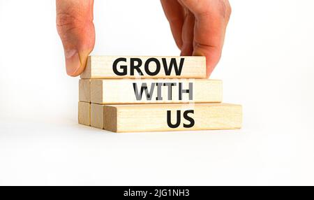 Grow with us symbol. Concept words Grow with us on wooden blocks on a ...