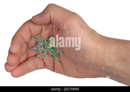 Side view of a hand holding microplastics with copy space. Non ...