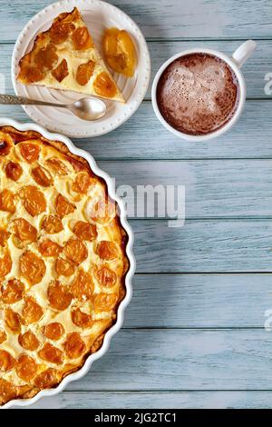 Homemade plum pie and cup of coffee on wooden table. Top view Stock ...