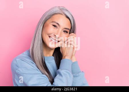 Photo of mature lady arms cheek look empty space wear orange pullover ...