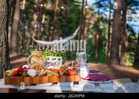 Picnic in the nature, table, carpets, wigwam, tent, pillows in the park ...