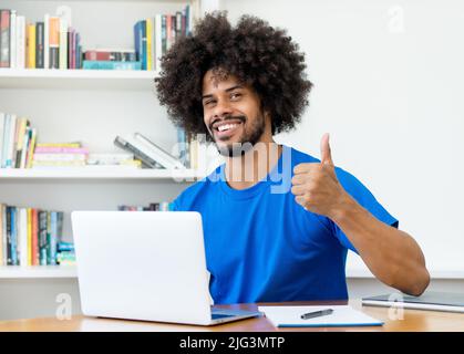 Laughing african american hipster software developer at computer at ...