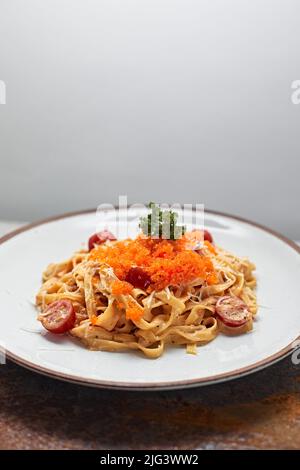 creamy sauce pasta with ebiko , selective focus Stock Photo - Alamy