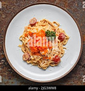 creamy sauce pasta with ebiko , selective focus Stock Photo - Alamy