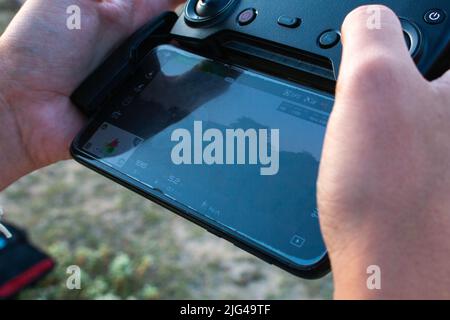 manly hands using a drone on the beach Stock Photo - Alamy