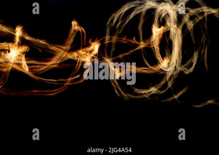 Circles of fire. Lines of flame. Shooting fire show on long shutter ...