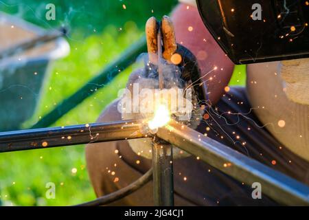 The arc welding electrode melts the metal. Selective focus. Sparks ...