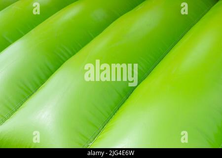 Green inflatable trampoline. Obstacle course. Details of amusement park ...