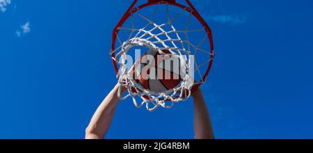 slam dunk in motion. summer activity. jumping man with basketball ball ...