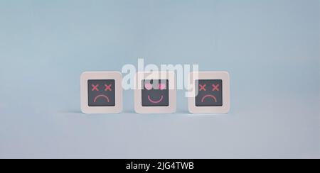 Set of computers with stylized faces of heart eyes and dead faces on ...