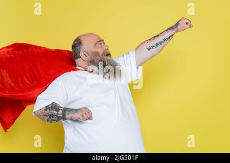bearded overweight man in superhero costume shouting with outstretched ...