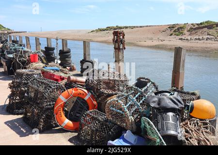 Lobster pots and other various pieces of fishing equipment piled up by ...