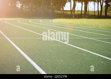 Running track at the stadium. Rubber coated green. Running track in the ...
