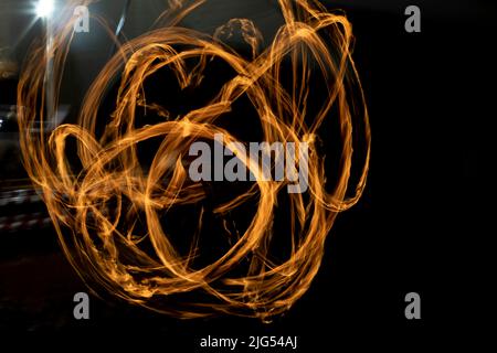 Circles of fire. Lines of flame. Shooting fire show on long shutter ...