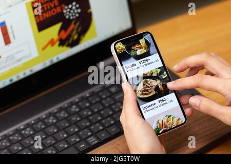 Japanese woman ordering food online Stock Photo - Alamy