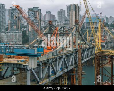 This is Chongqing, China, where a bridge is being built over a large ...