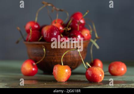 Still life with ripe and tasty cherries in a silver bowl Stock Photo ...