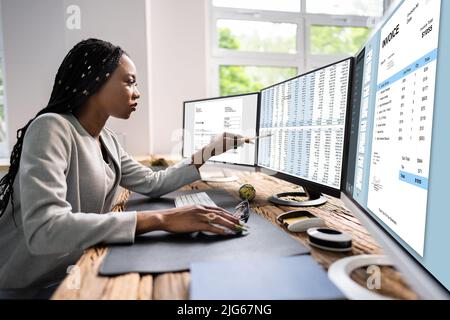 Spreadsheet And Electronic Invoice On Multiple Computer Screens Stock ...