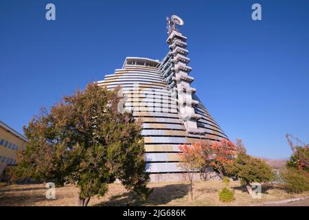 The silver banded curved back of the main reflector building at the ...