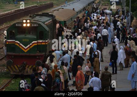 Pakistani people boarding on the roof top of a crowded train as they ...
