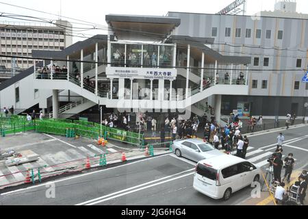 Police officers investigate the scene where Japan's former Prime ...