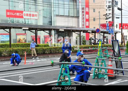 Police officers investigate the scene where Japan's former Prime ...