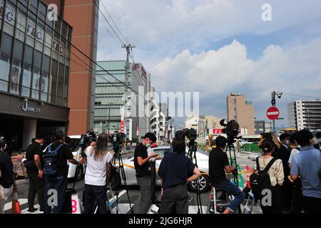 Police officers investigate the scene where Japan's former Prime ...