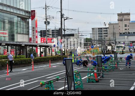 Police officers investigate the scene where Japan's former Prime ...