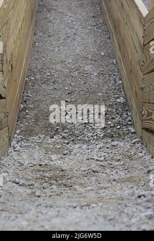 A wooden corral to guide animals towards their pens in black and white ...