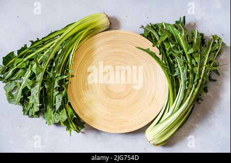 Chicory greens in colander on white wooden table. Top view Stock Photo ...