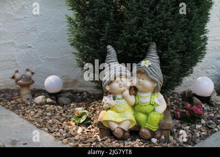 small funny figures of green clothed people Stock Photo - Alamy