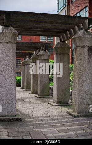 Colonnade of a contemporary building with concrete columns decorated ...