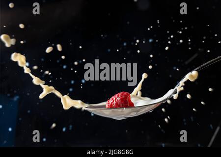 raspberry falls in milk splash Stock Photo - Alamy