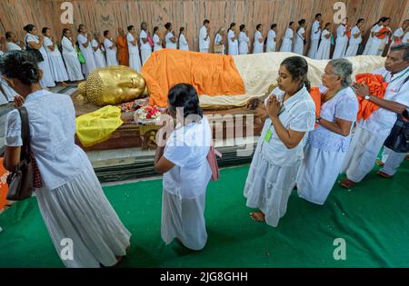 08 28 2008 Devotees offering water and Flower to statue of lord buddha ...