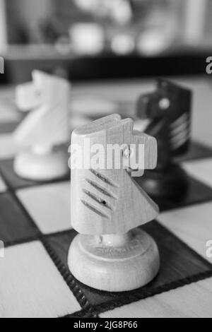A vertical grayscale shot of chess pieces on a board Stock Photo - Alamy