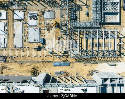 Aerial view of cement plant with high factory structure and tower crane ...
