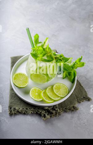 Mojito cocktail on concrete. Glass of mojito with mint and lime on a ...