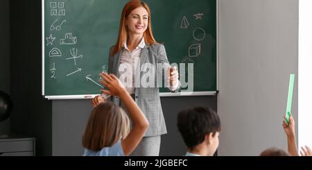 Maths teacher conducting lesson in classroom Stock Photo - Alamy