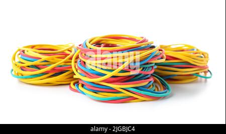 Three stacks of colorful rubber bands isolated on white background ...