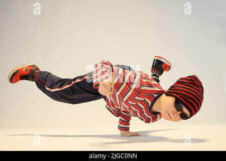 boy in breakdance position, difficult dance position, stands on one ...