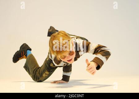 boy in breakdance position, difficult dance position, stands on one ...