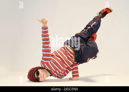 boy in breakdance position, difficult dance position, stands on one ...