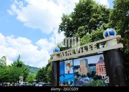 Metal Asheville cutout sign in stylized font and lettering above a city ...
