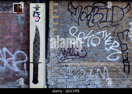 Street art of a knife and more with graffiti sprays. Waterloo, London ...