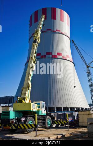Industrial construction site. Construction of metal cylindrical silos ...