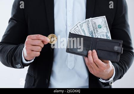 Closeup shot of a male holding a bitcoin and his phone - bitcoin ...