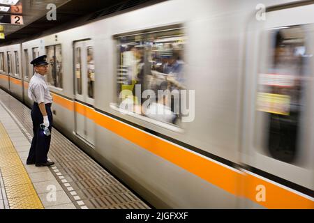 Departing subway train conductor signals Tokyo Japan Stock Photo - Alamy