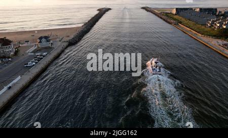 Aerial view of boat on the Manasquan Inlet heading to the Atlantic ...