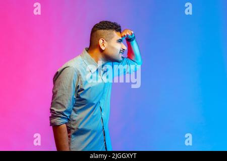 Hispanic man standing over pink background showing and pointing up with ...