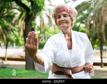 Mature lady in kimono exercising outdoors Stock Photo - Alamy